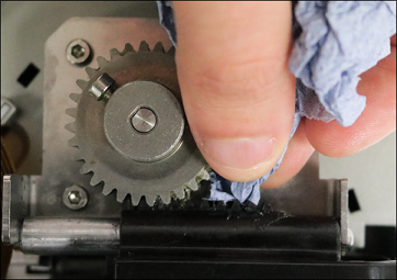 Cleaning and reapplying grease to slide rail and drive gear ...